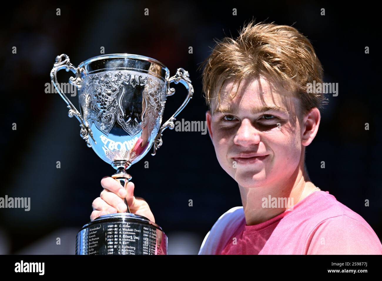 Henry Bernet of Switzerland holds the winners trophy following his ...