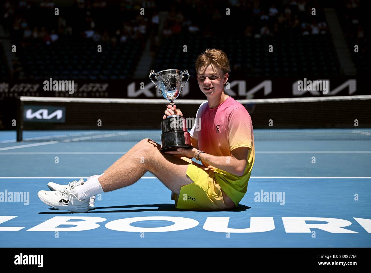 Henry Bernet of Switzerland holds the winners trophy following his ...