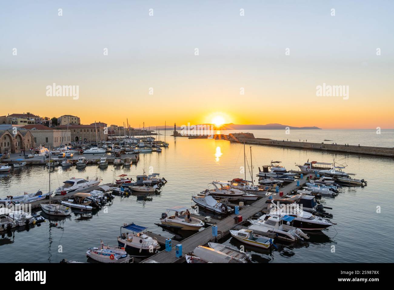 Chania Crete - August 14 2024; Bay and marina with golden sunset rays ...