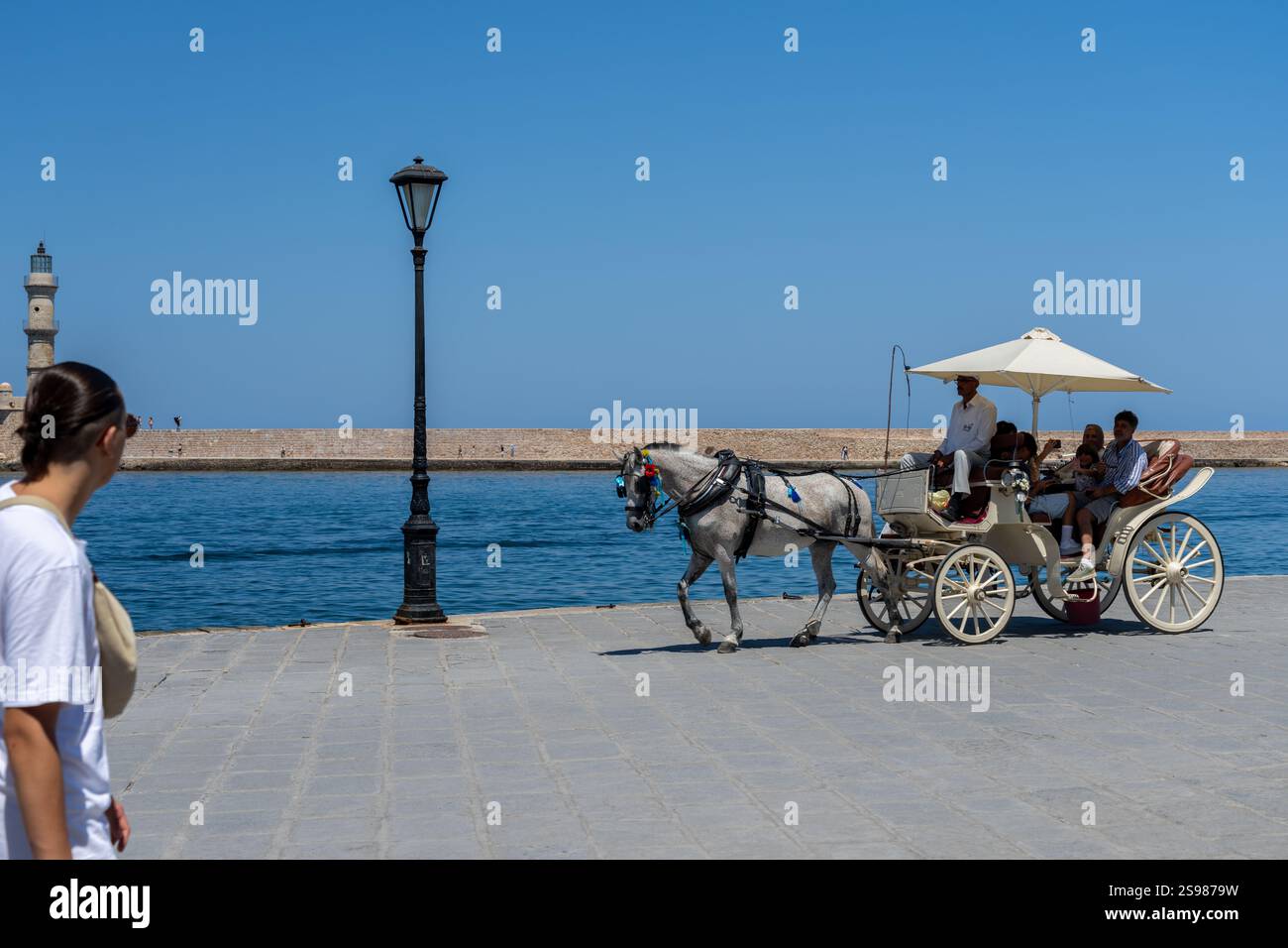 Chania Crete - August 15 2024; White horse slowly pulling carriage of ...