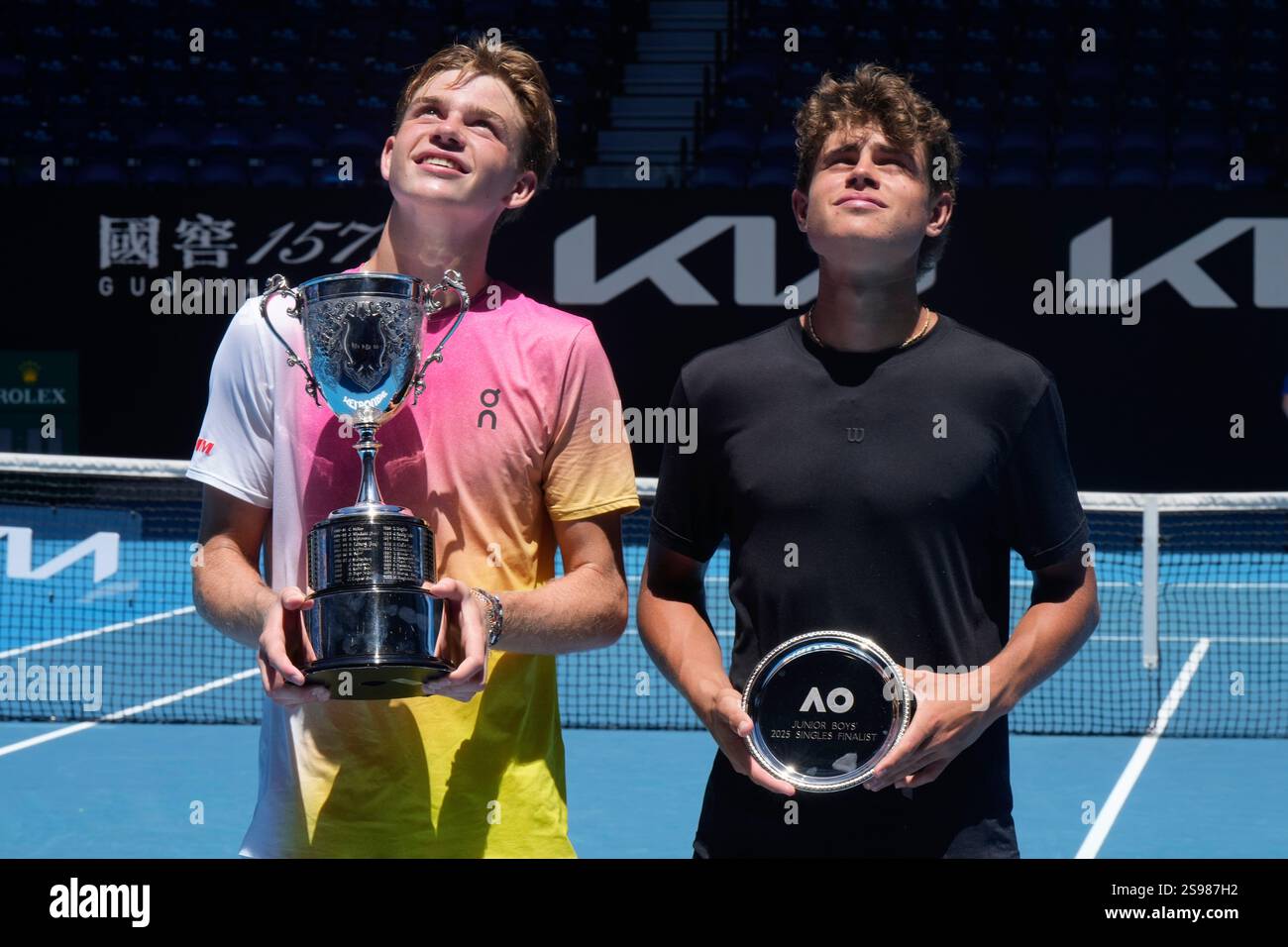Henry Bernet, left, of Switzerland holds his trophy after defeating ...
