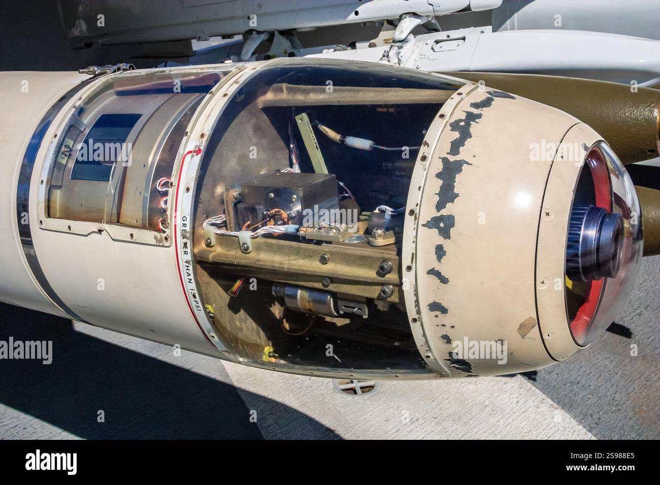 A small airplane engine is shown with a clear window. The engine is old ...