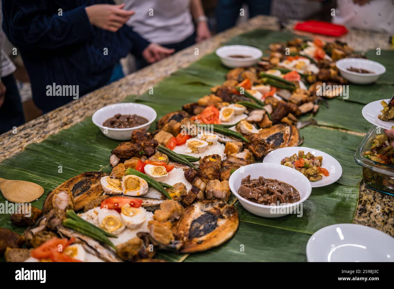 Guests enjoy a feast together Stock Photo - Alamy