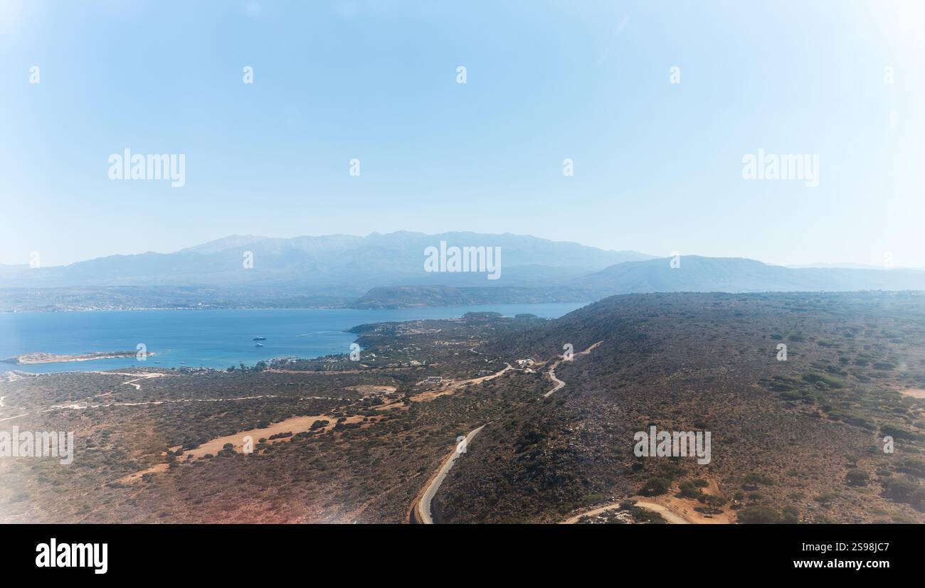 Aerial image through plane window of Greek Island of Crete while flying ...