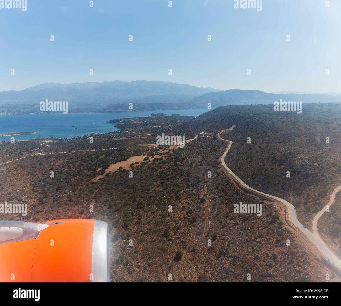Aerial image through plane window of Greek Island of Crete while flying ...