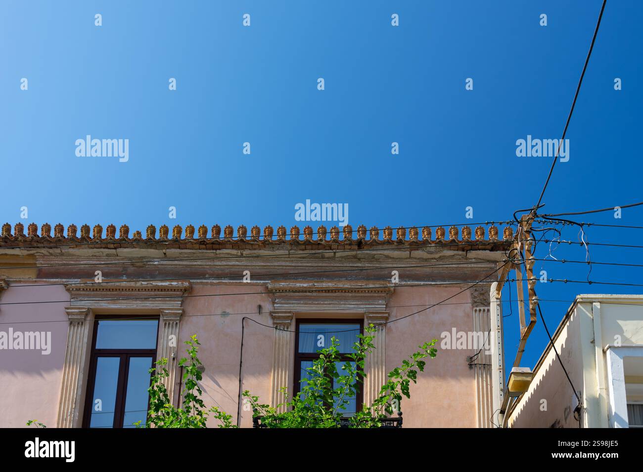 Building facade with Greek style details including windows and row of ...