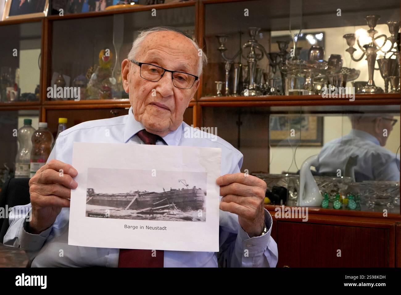 Manfred Goldberg, a Holocaust survivor displays a photograph of the ...