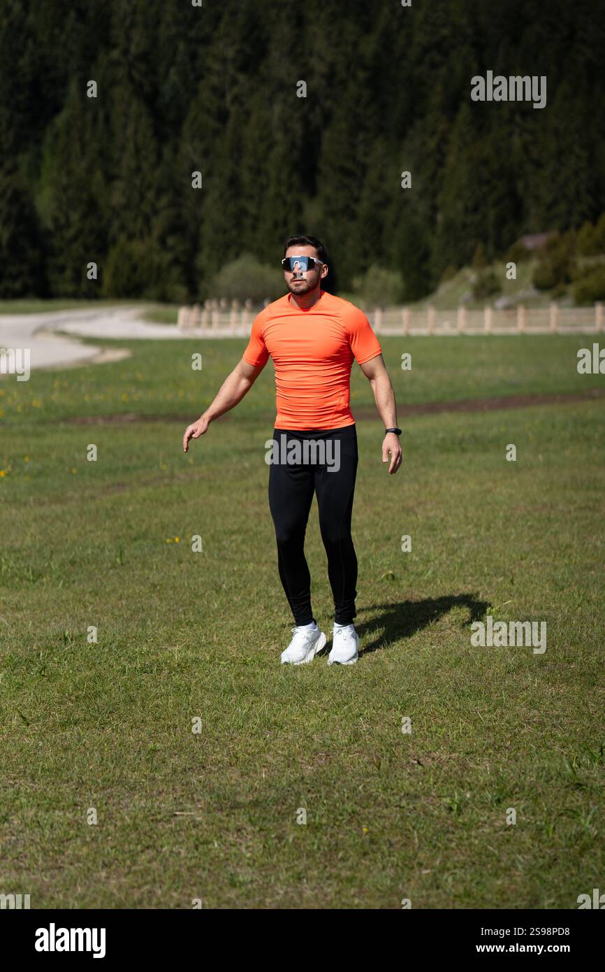 Man Practicing Dynamic Warm-Up Movements On Grass In Nature Stock Photo ...