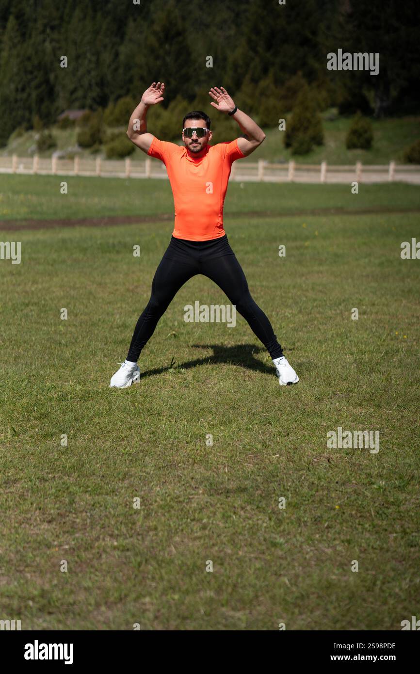 Outdoor Warm-Up Exercise With Jumping And Stretching Movements Stock ...