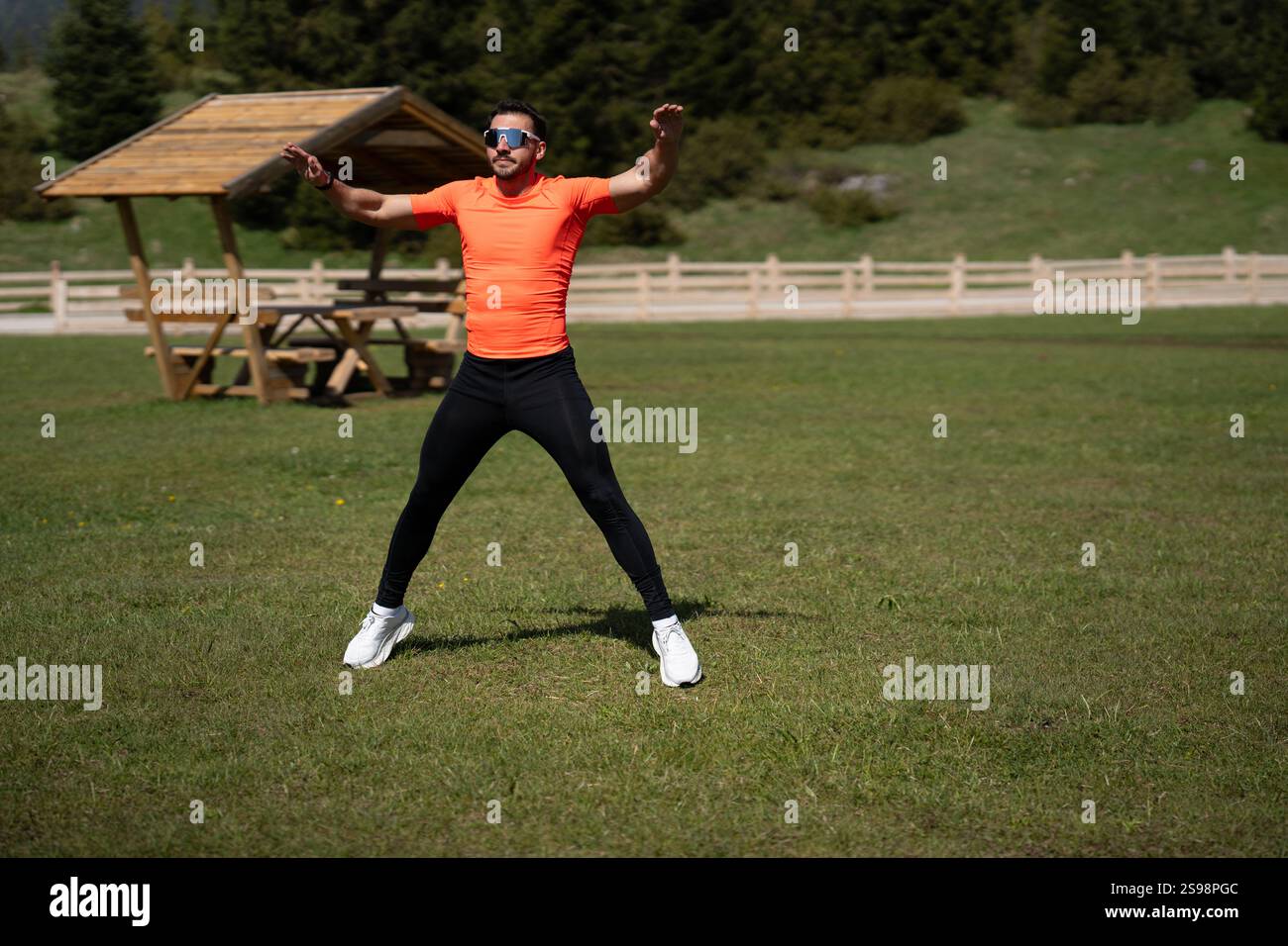 Outdoor Warm-Up Exercise With Jumping And Stretching Movements Stock ...