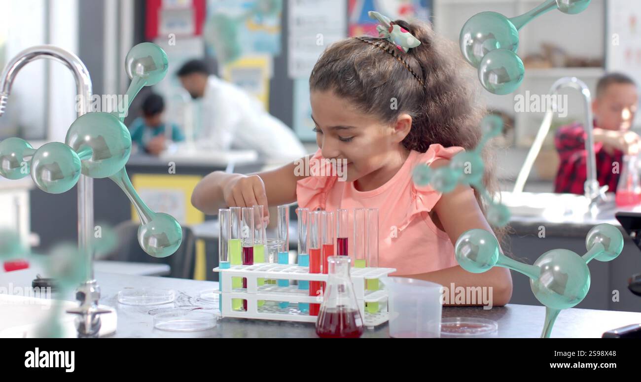 Conducting science experiment, girl in classroom with molecule image ...