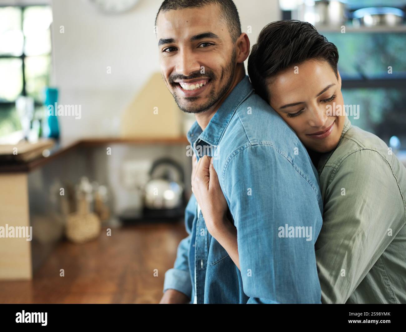 Happy, couple and hug with love in kitchen of care, healthy ...