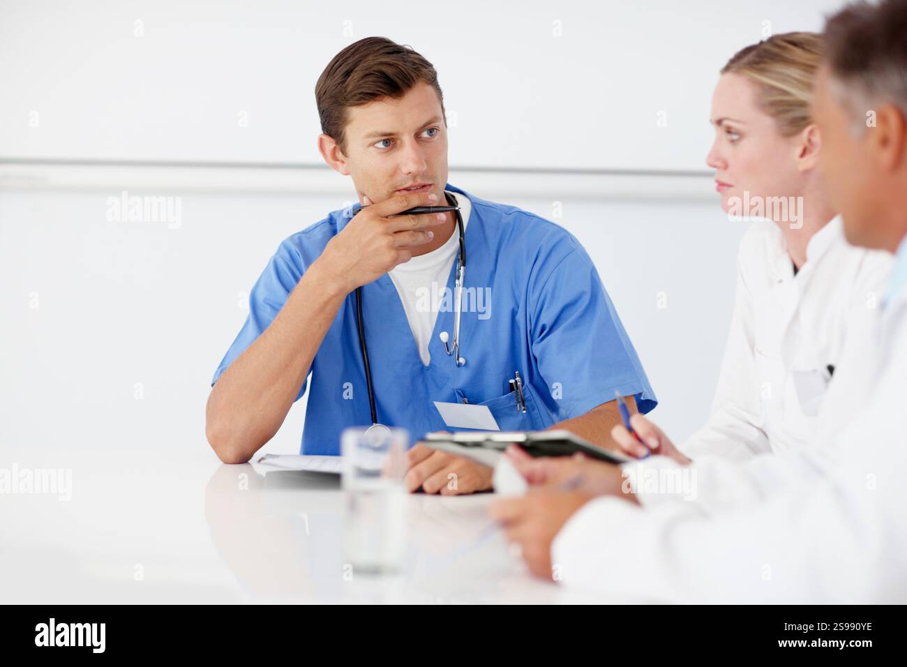 Doctors, man and discussion at clinic for planning, confused and ...