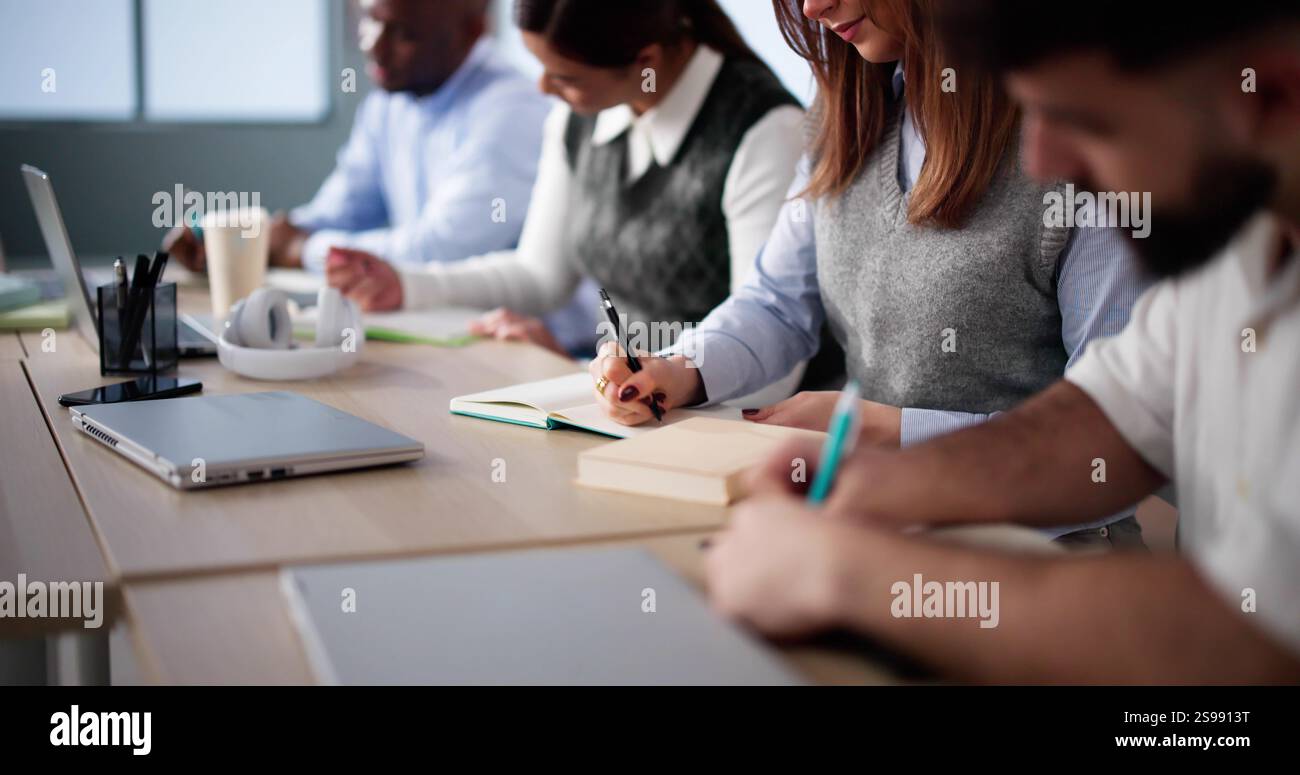 Studying In Classroom At Campus. Students Writing In Class Stock Photo ...