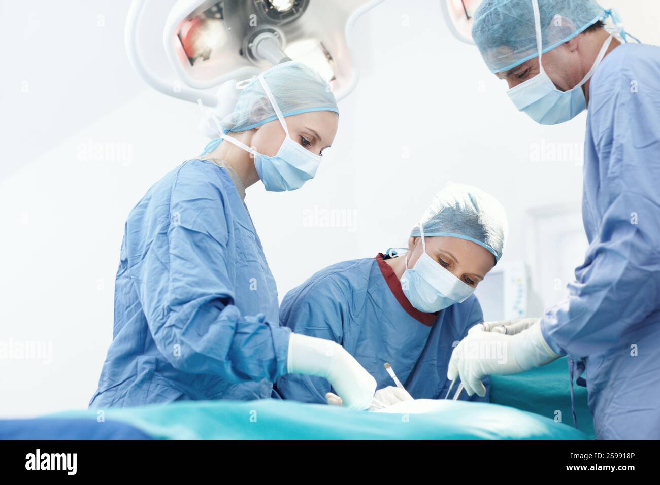Hospital, specialist and doctor procedure in operating room for patient ...
