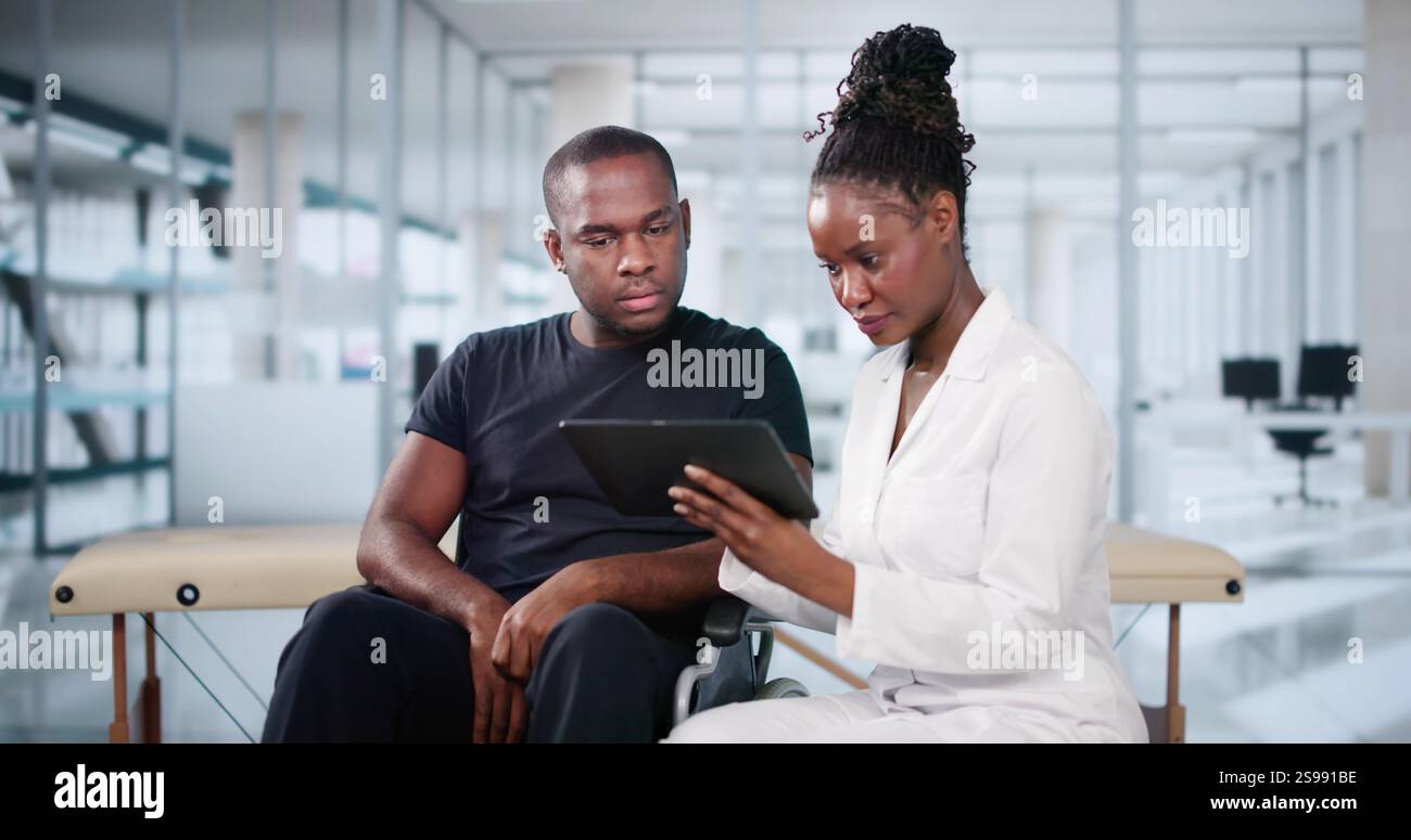 Happy African Doctor With Male Patient In Hospital Using Tablet Stock ...