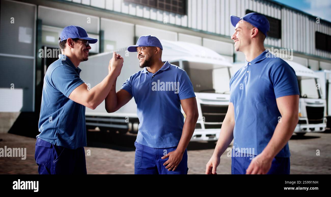 Diverse group of happy truck drivers shaking hands at warehouse Stock ...