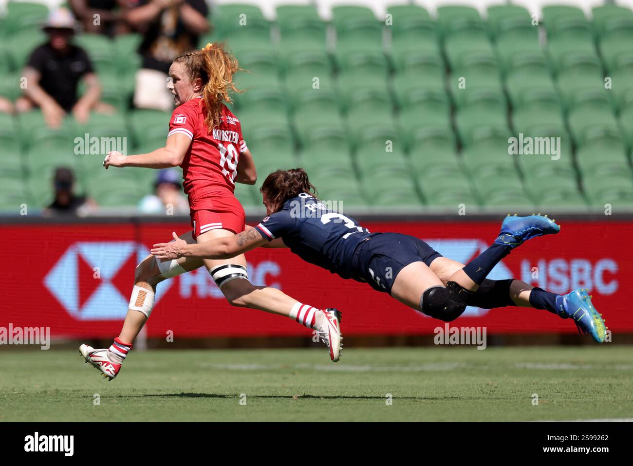 Carissa Norsten of Canada runs in for a try under pressure from Alyssa ...