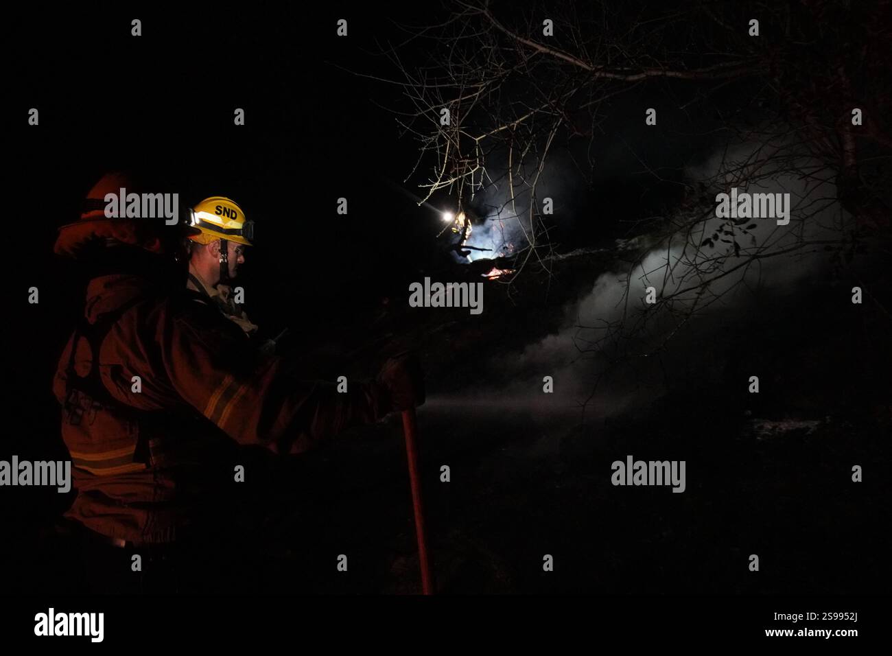 A firefighter battles with the wildfire on the mountain near the US ...