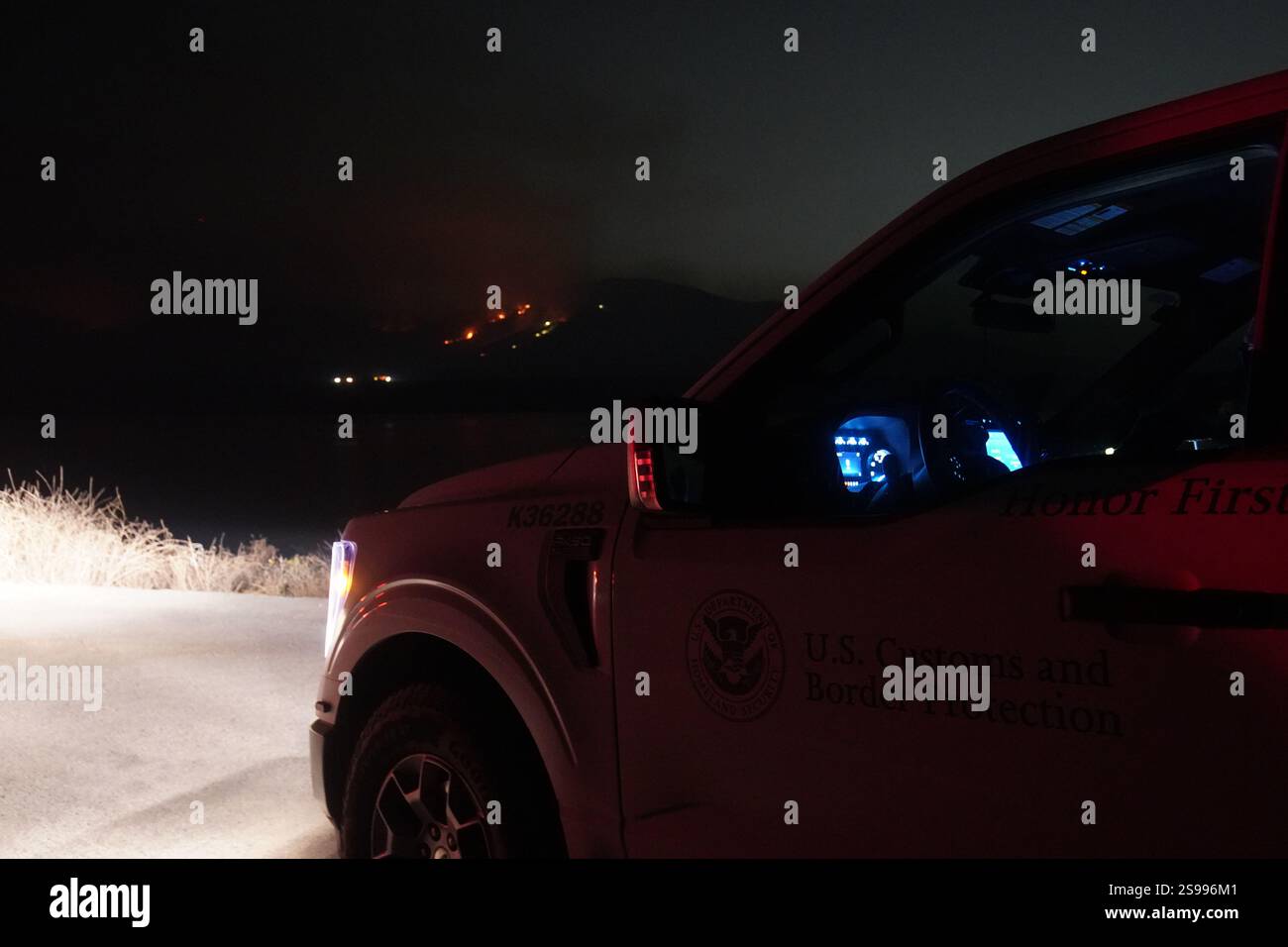 A border patrol vehicle is parked on Otay Lake Road while the wildfire ...