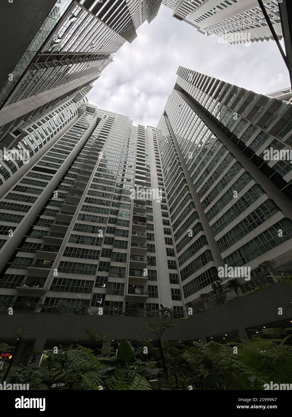 A circle of open sky surrounded by the modern architecture of Kuala ...