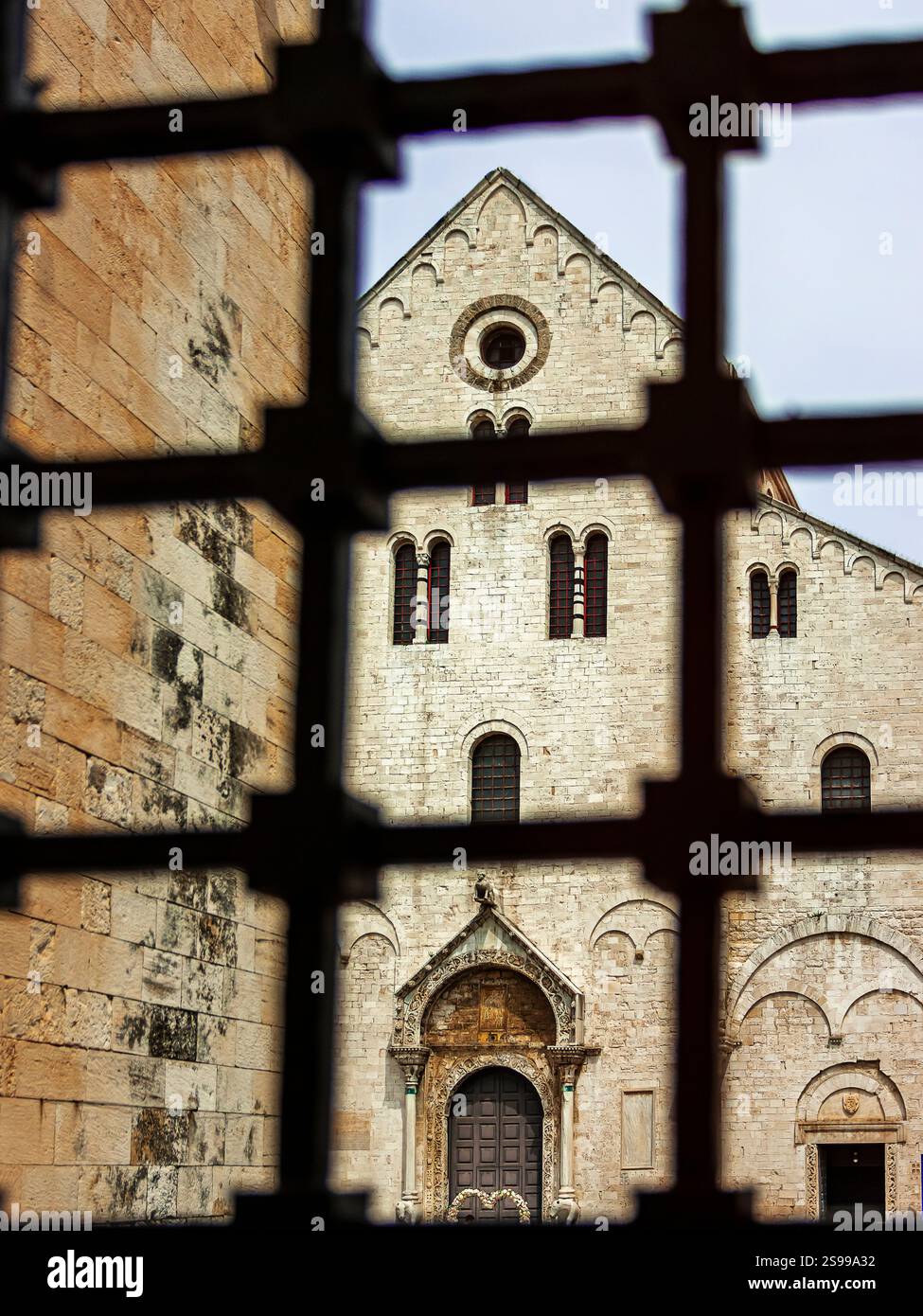 the facade of the church of San Nicola in Bari seen through a window ...