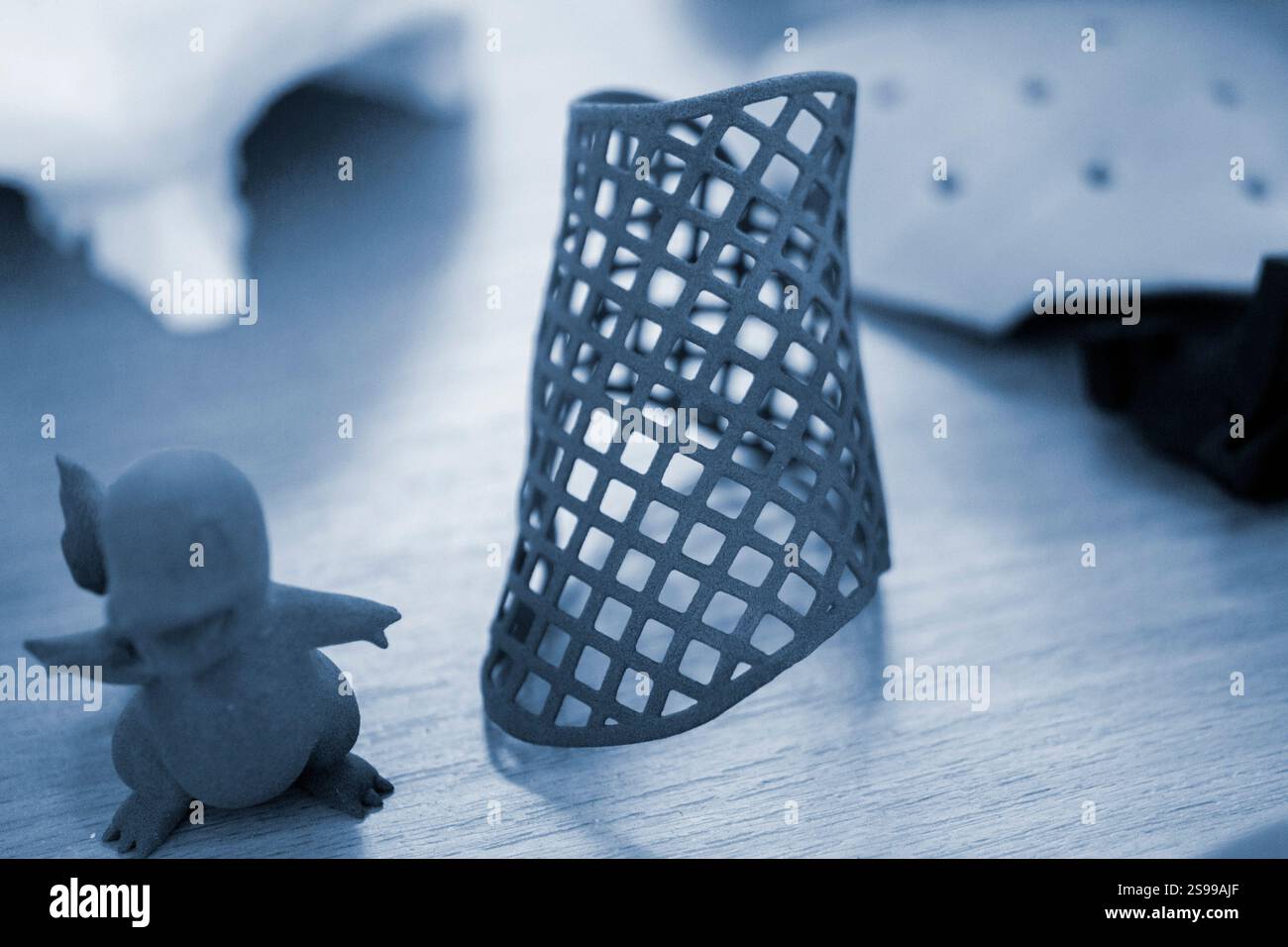 Objects printed on 3D printer from molten plastic powder. Different models printed on 3D printer ...