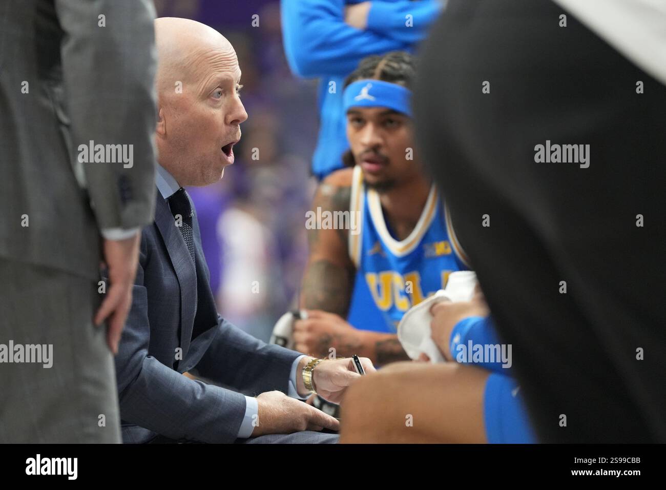 UCLA Bruins head coach Mick Cronin huddles with his team during a time ...