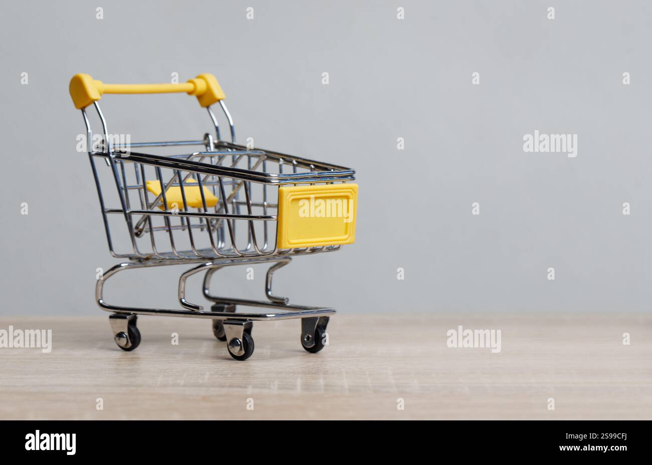 Shopping cart with yellow details indoor Stock Photo - Alamy