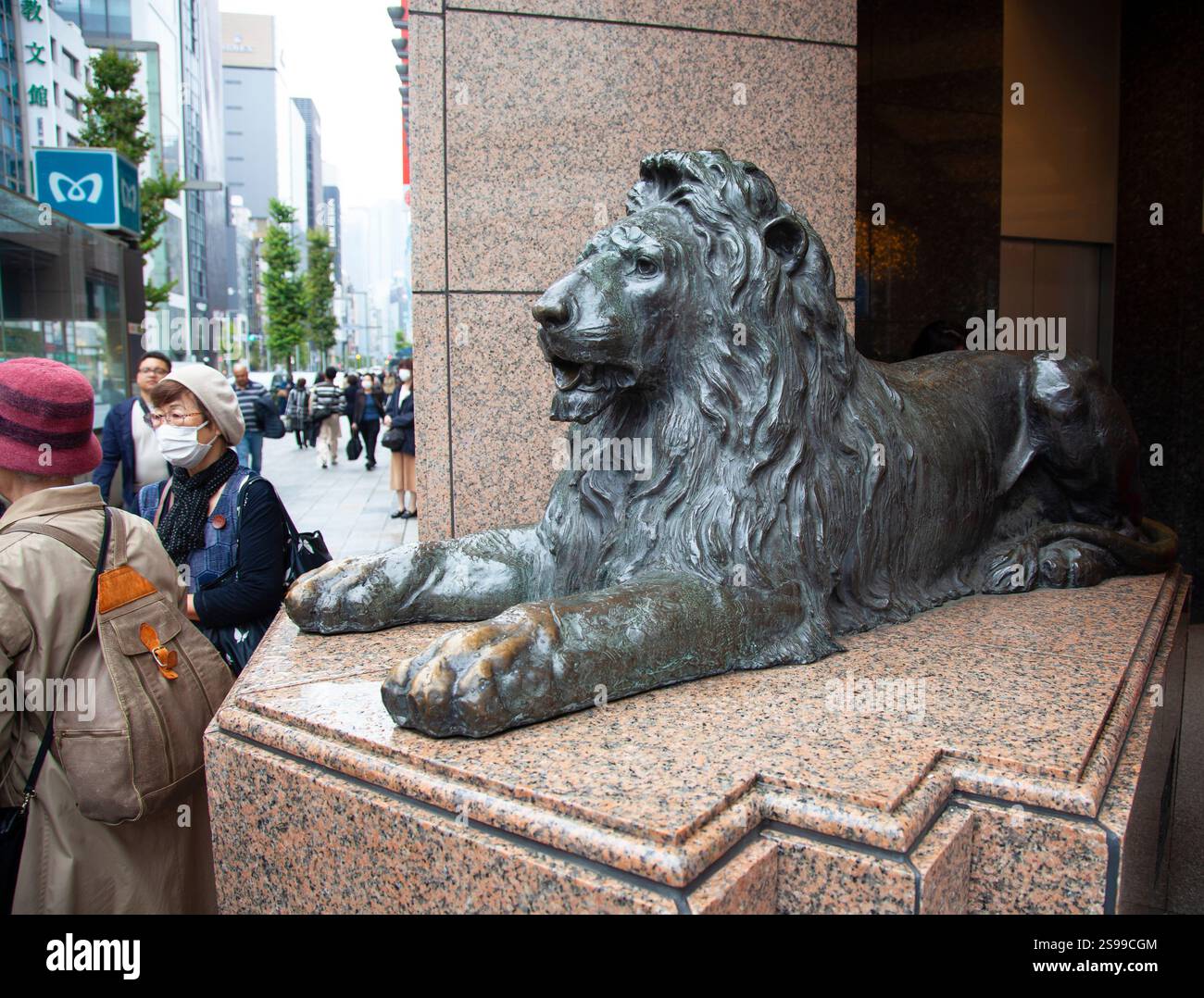 A bronze lion statue outside the main entrance of the Mitsukoshi ...