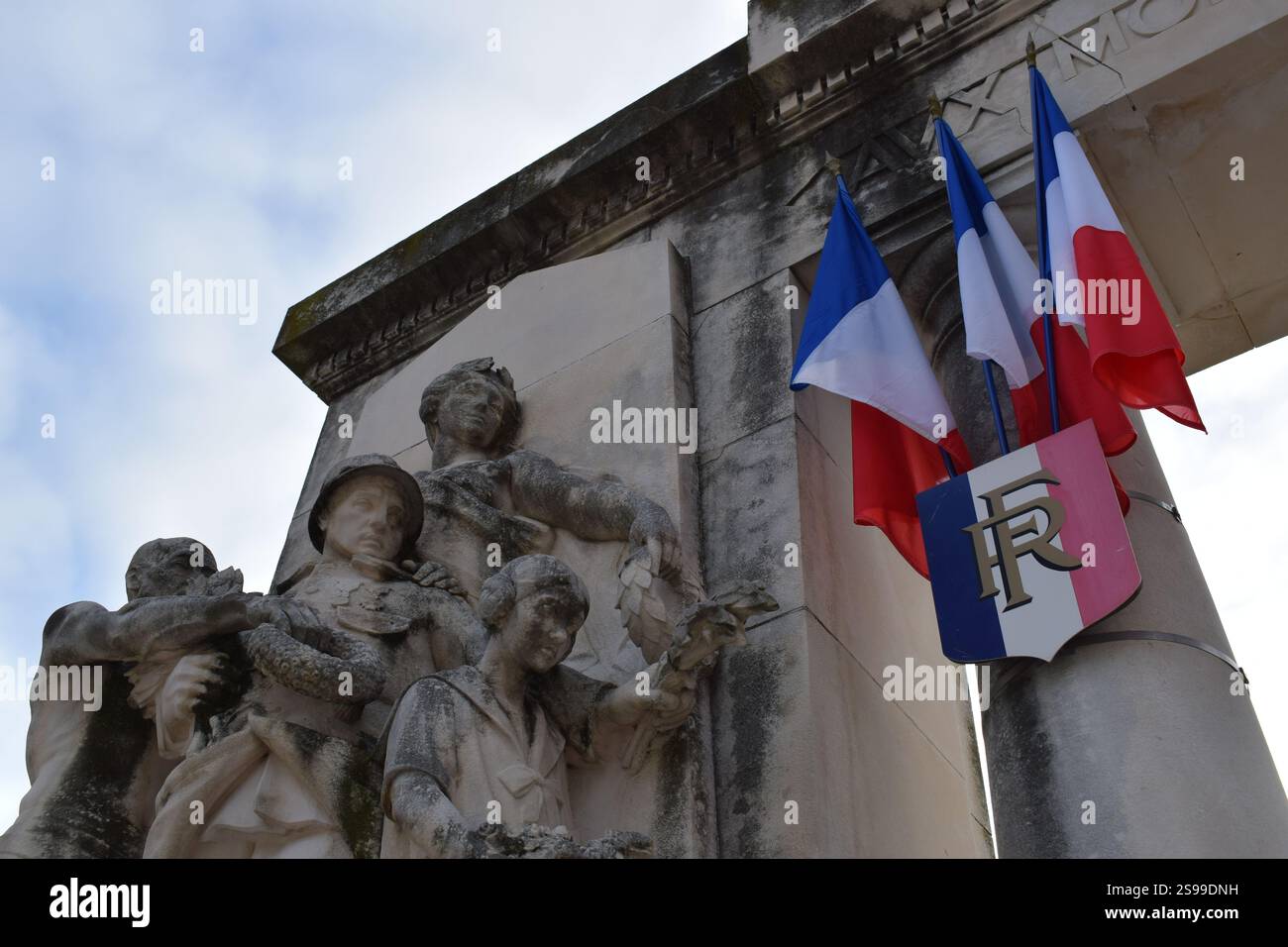 Monument displaying French flags and historic sculptures located in a ...