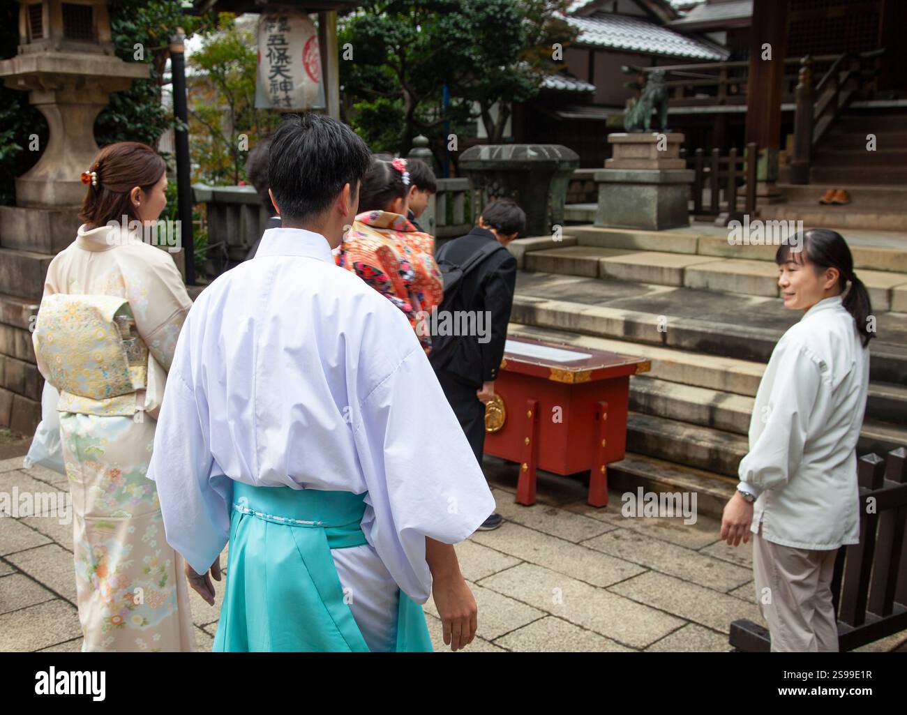 A priest with visitors at the Gojoten Shrine in Ueno Park, Tokyo, Japan Stock Photo - Alamy