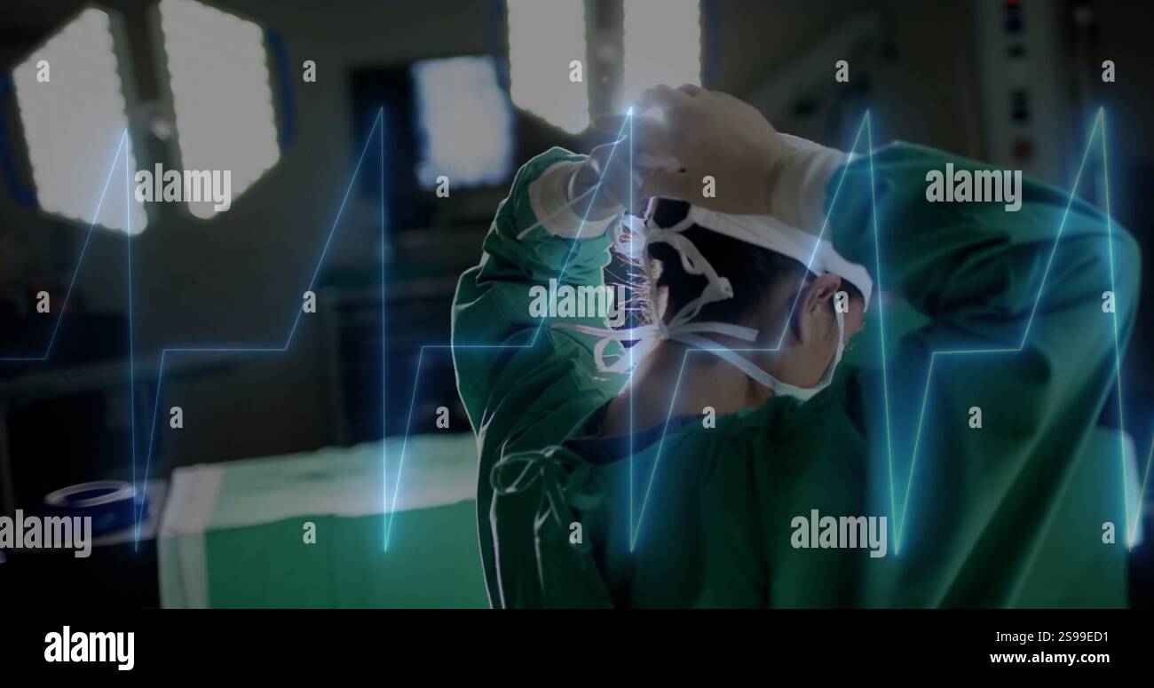 Adjusting surgical cap, medical professional in operating room with ...