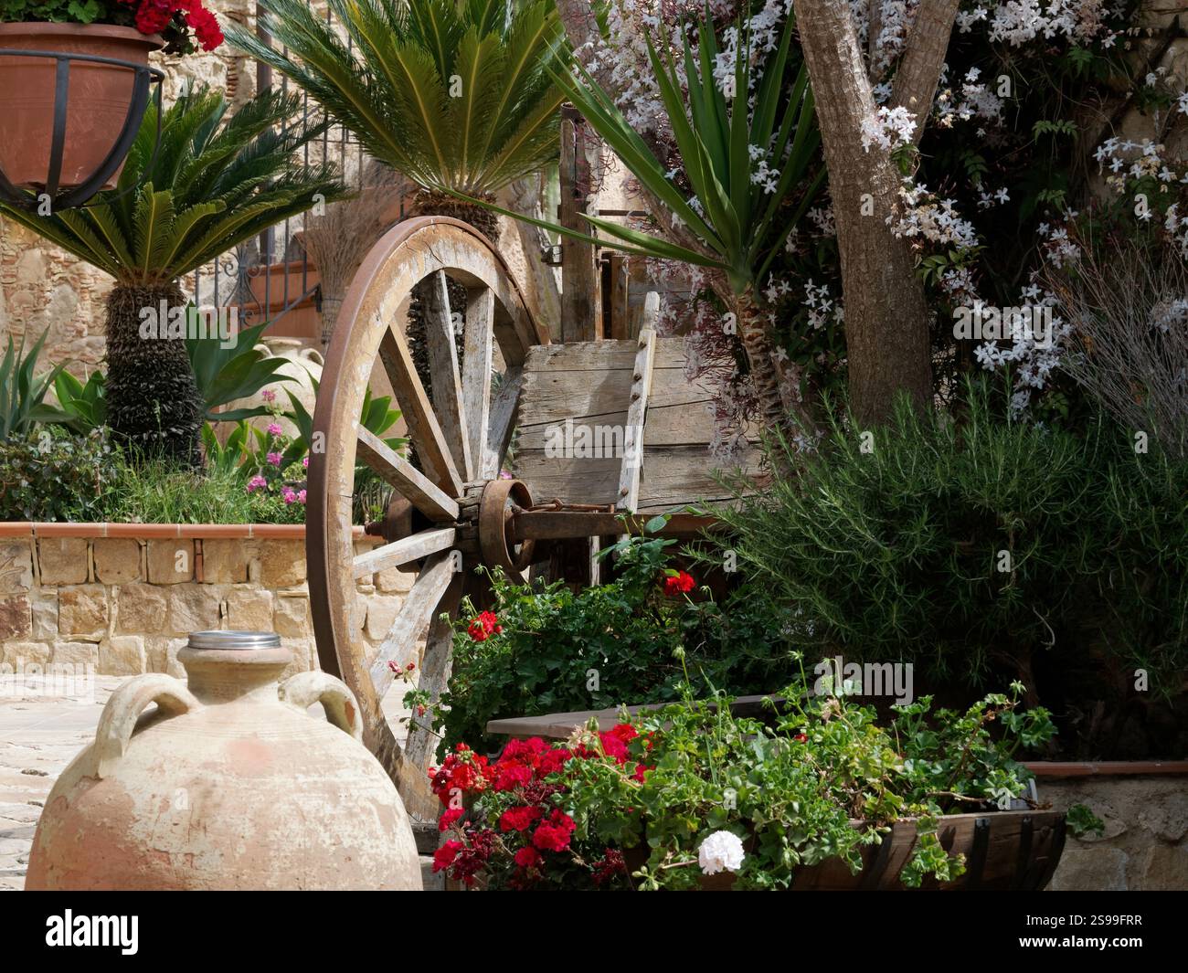 Rustic Garden Courtyard with Wheel Cart and Flower Decorations Stock ...