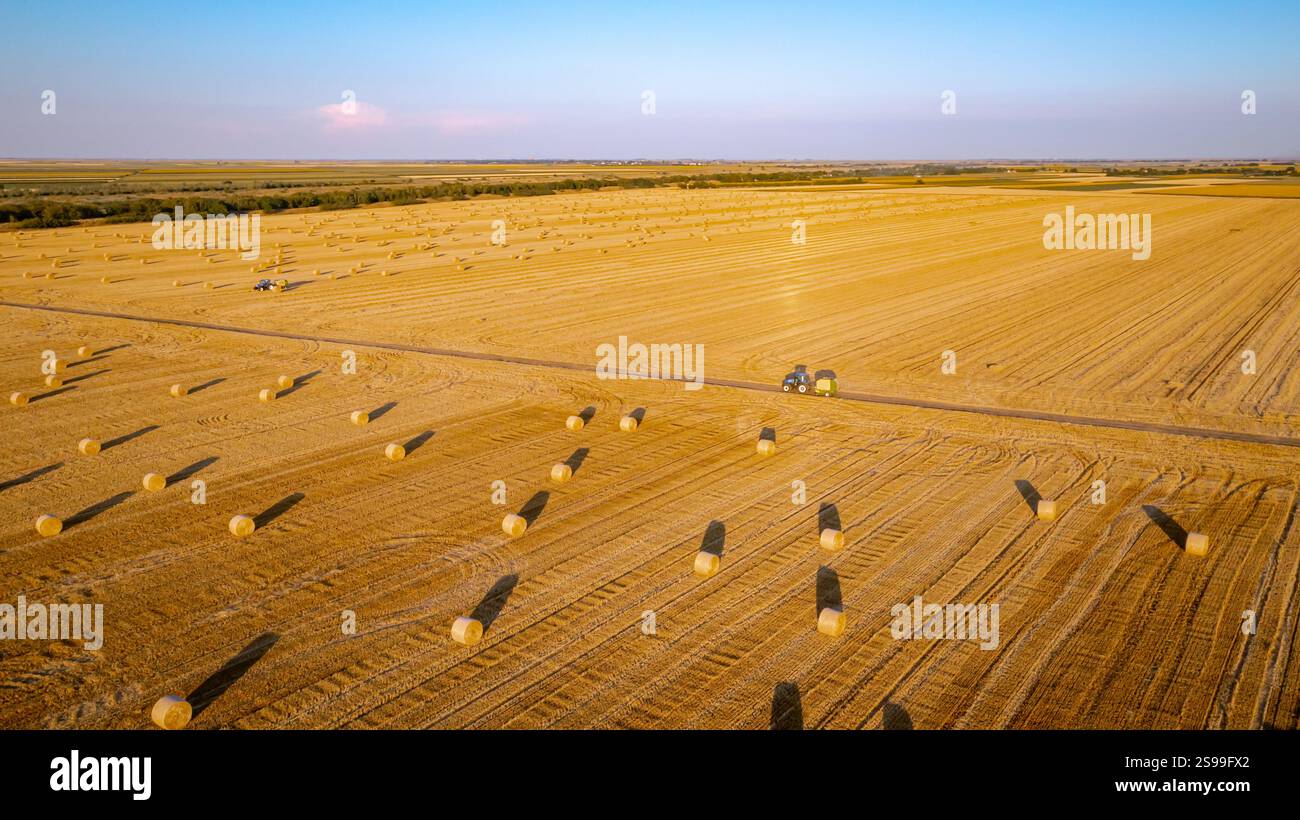 Above high view on two tractors as they pulling round baler, machines ...