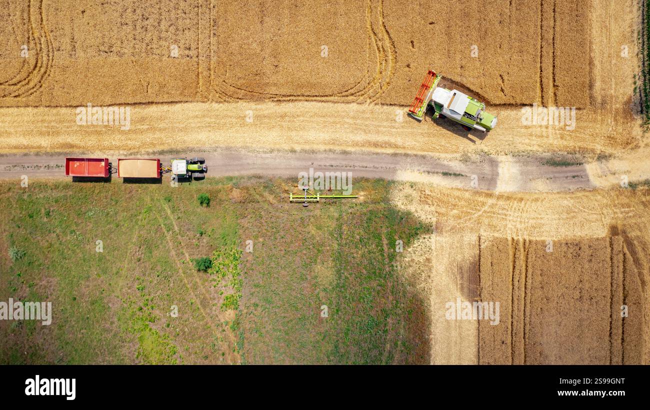 Above top view over agricultural harvester, combine as he cutting and ...