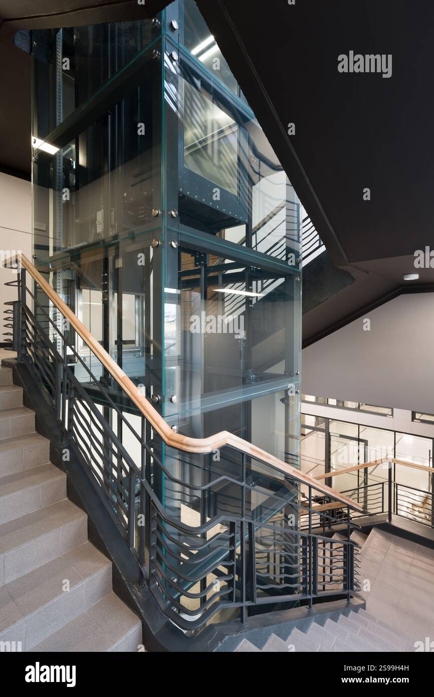 Modern Glass Elevator and Winding Staircase Design Stock Photo - Alamy