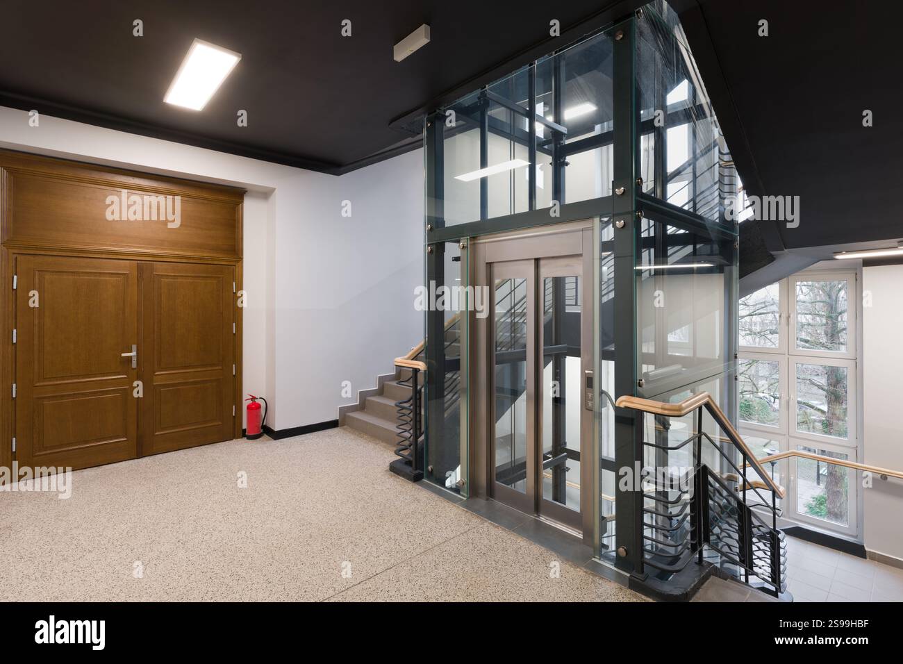 Interior View of a Building with Glass Elevator and Wooden Doors Stock ...