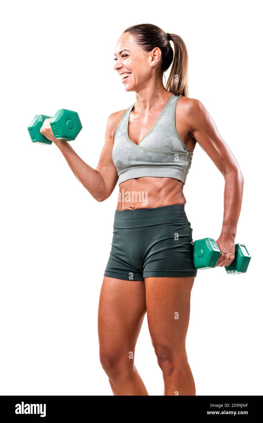 Active and confident woman smiling while performing dumbbell exercises ...