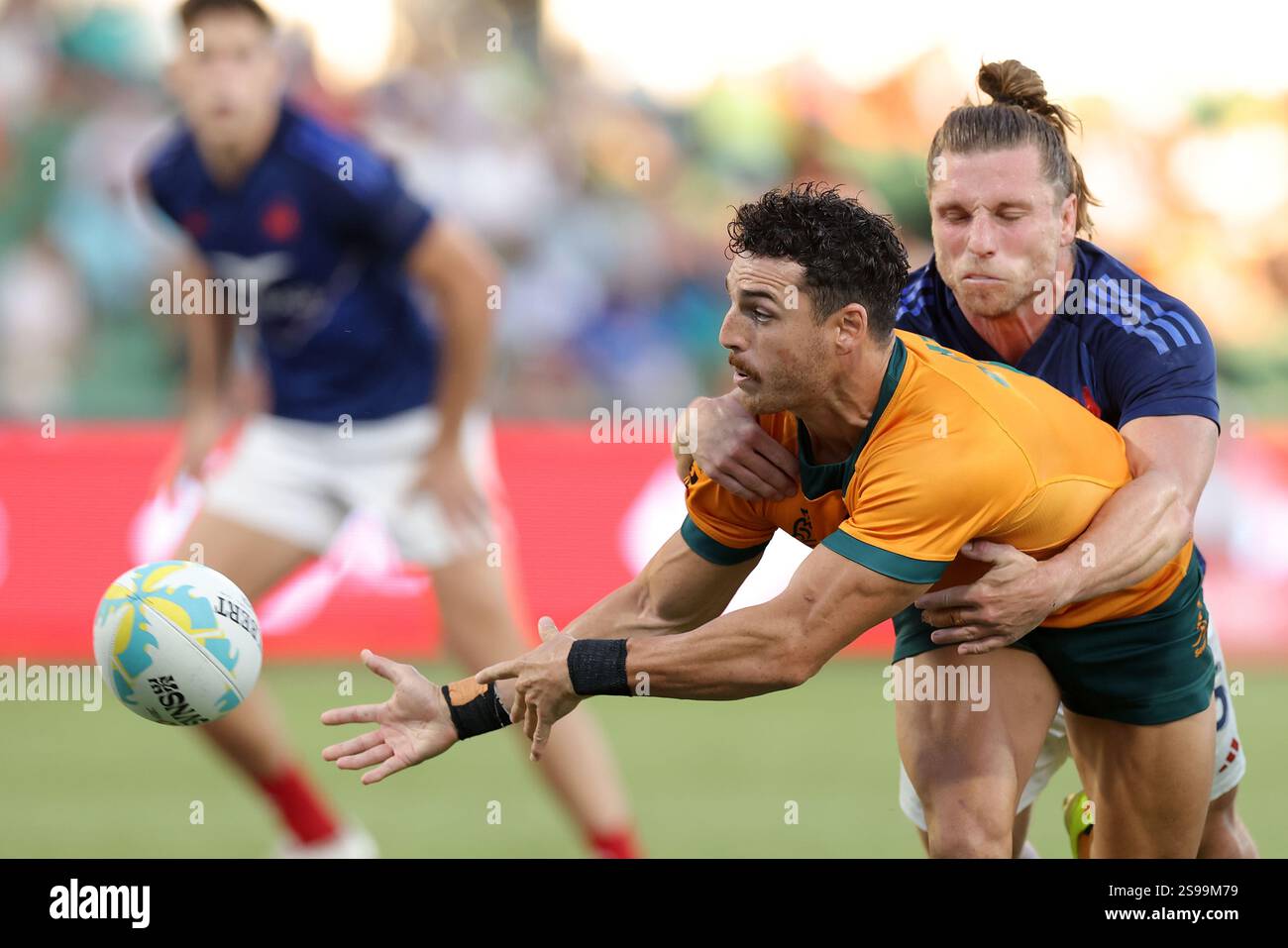 Matt Gonzalez of Australia passes the ball under pressure from Stephen ...