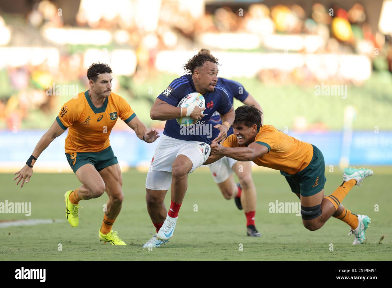 Liam Delamare of France is tackled by Aden Ekanayake of Australia ...