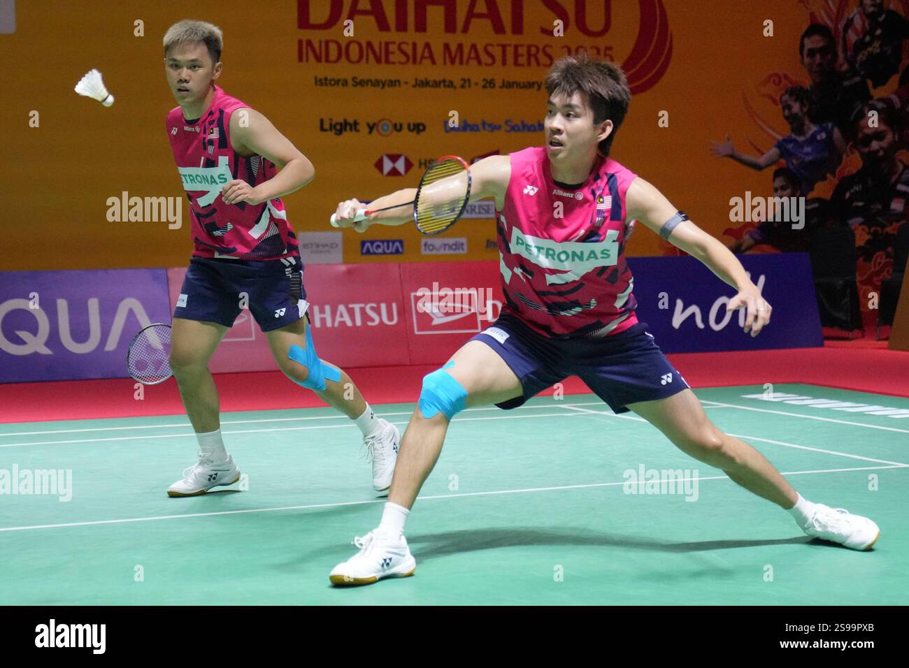 Man Wei Chong, left, and Kai Wun Tee of Malaysia play against Aaron ...