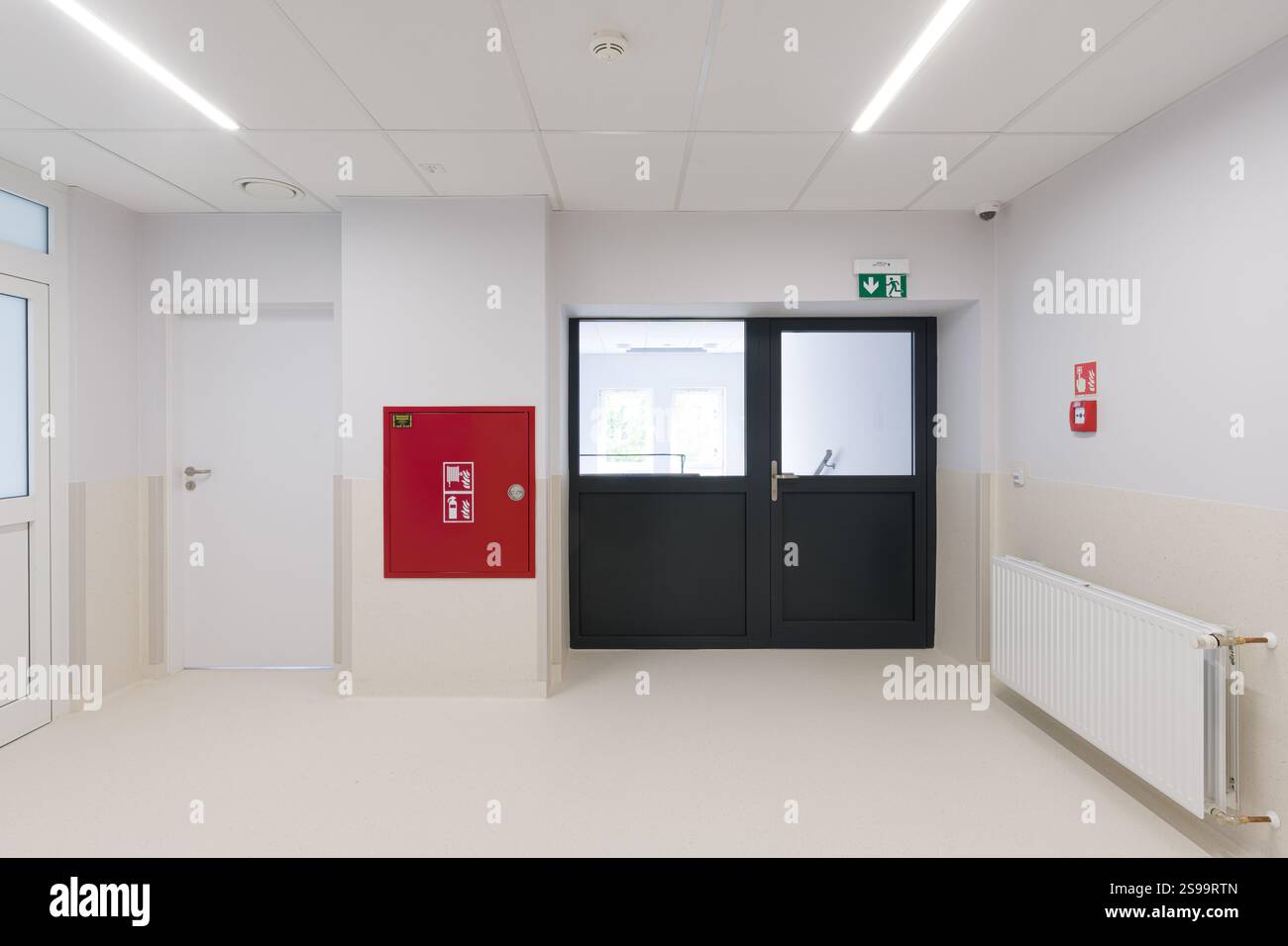 Modern Hallway with Multiple Doors and Fire Safety Equipment Stock ...