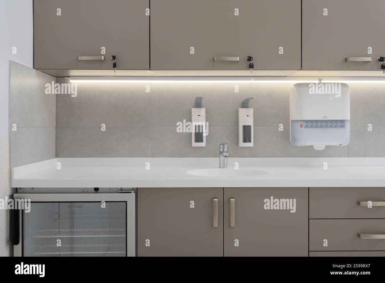 Modern Sink Area with Soap Dispensers and Paper Towel Holder Stock ...