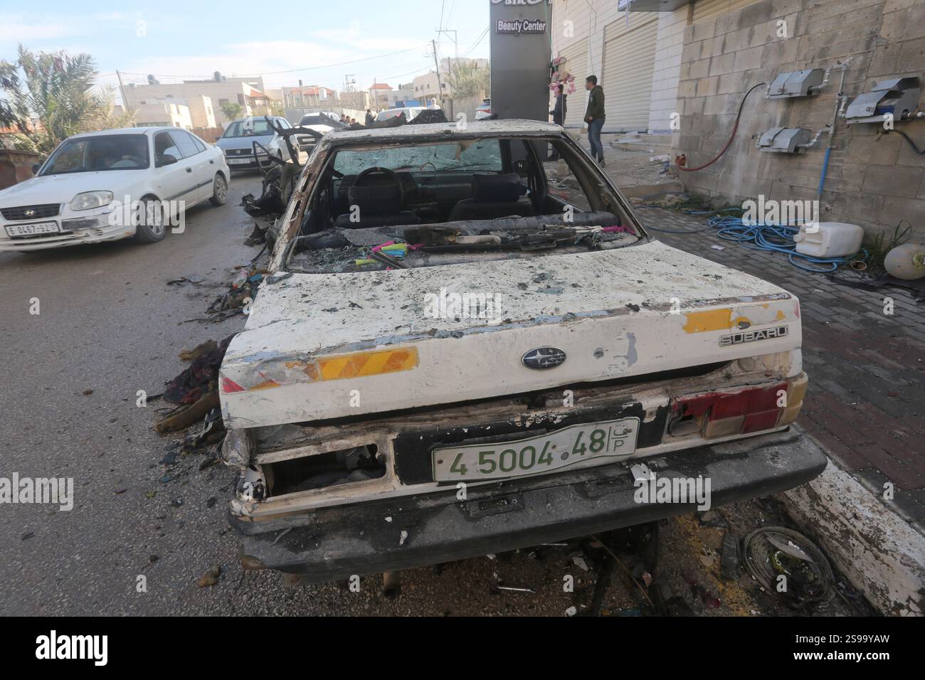 A car bombed by an Israeli drone is seen by the roadside in the town of ...