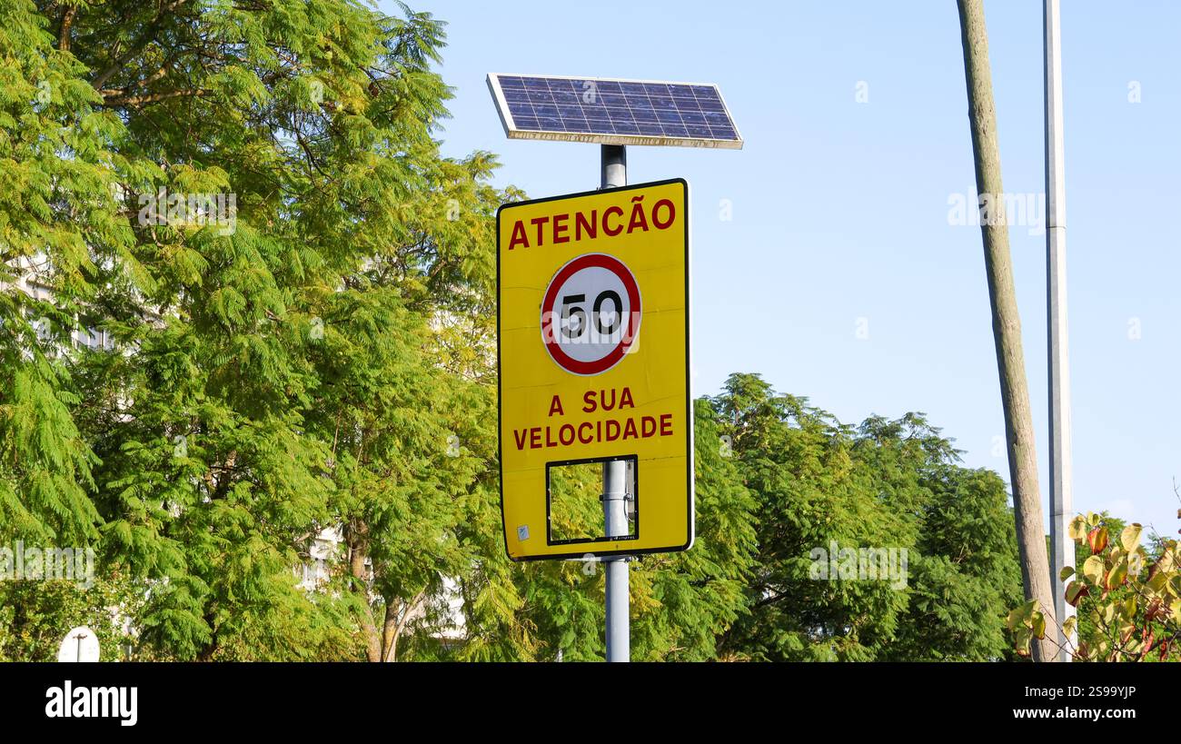 Electronic speed limit sign powered by a solar panel displaying 50 kmh ...