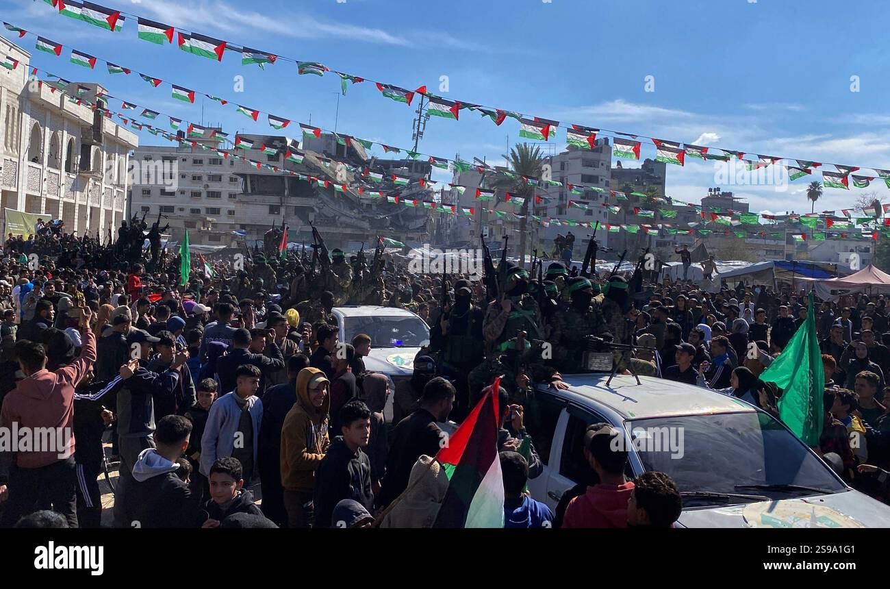 Hamas fighters secure an area in a square before handing over four ...