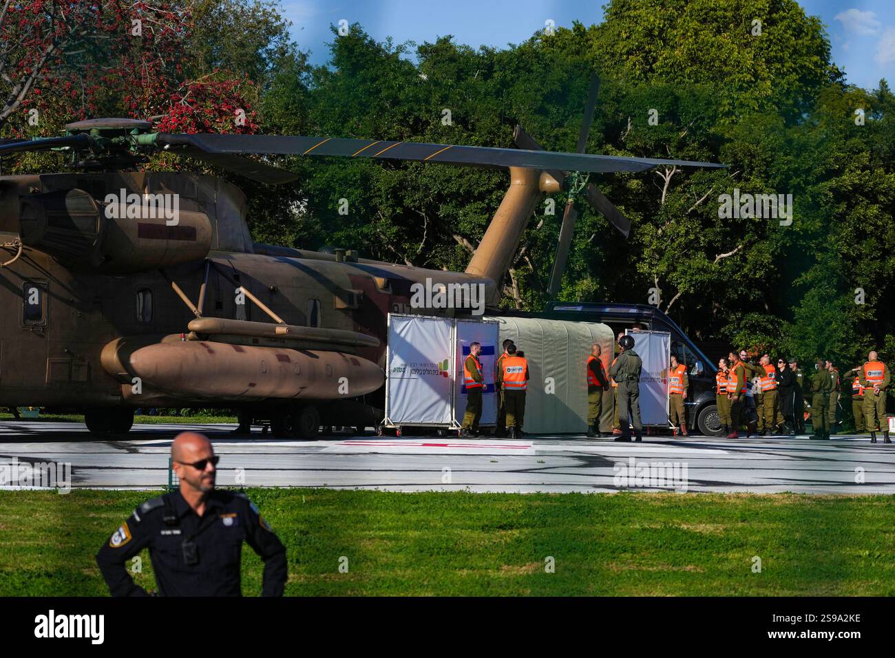 Israeli staff and military stand next to the military helicopter ...
