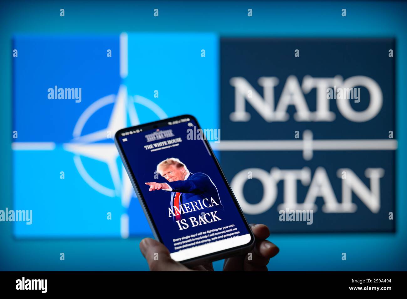 The White House website is displayed on a mobile phone with NATO - OTAN ...