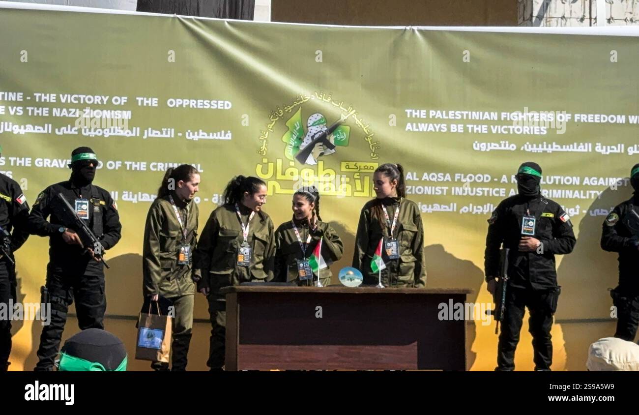 Hamas fighters escort four Israeli soldiers prisoners on a stage before ...